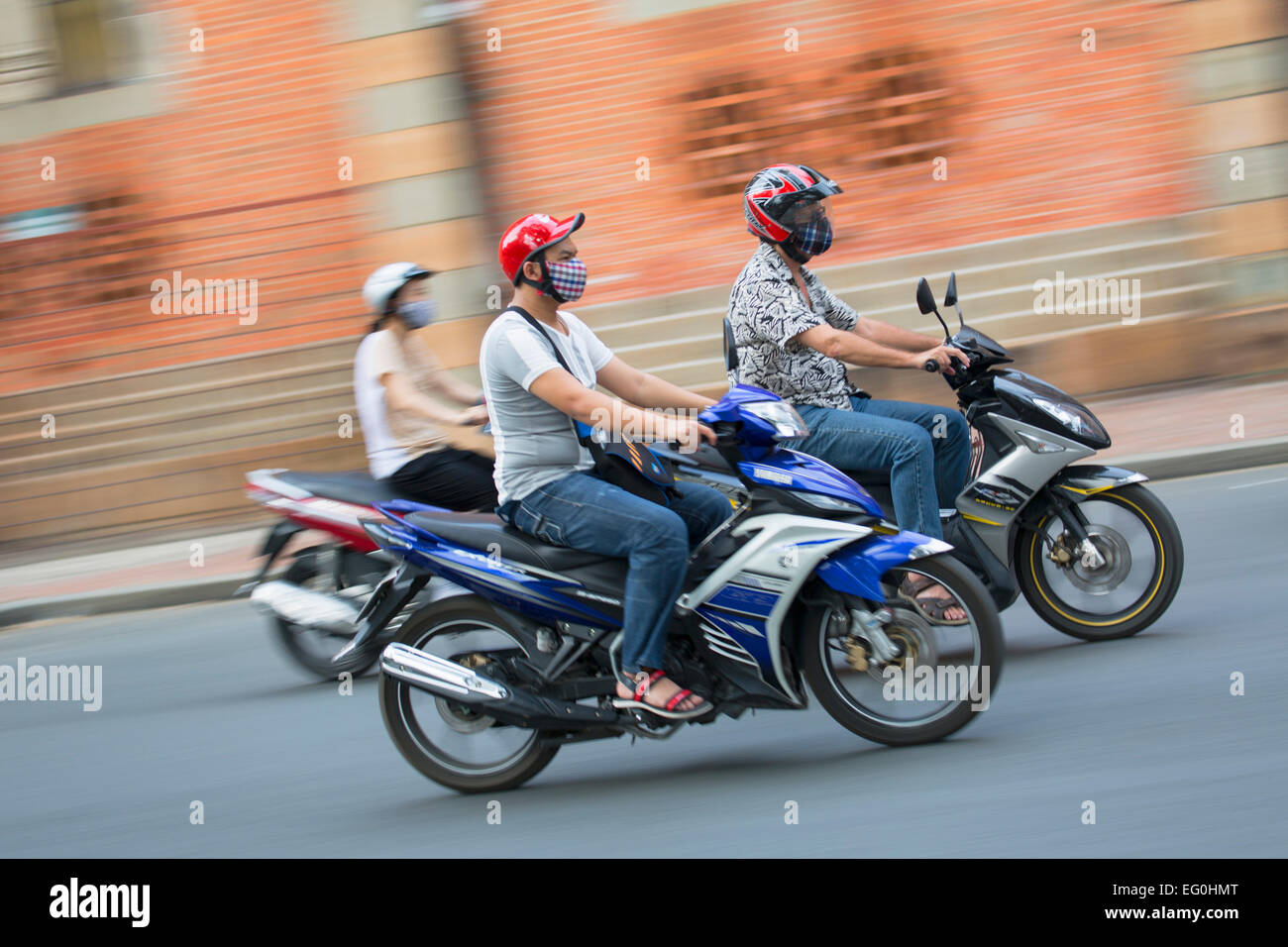 People riding motorbikes passing Notre Dame Cathedral, Ho Chi Minh City ...
