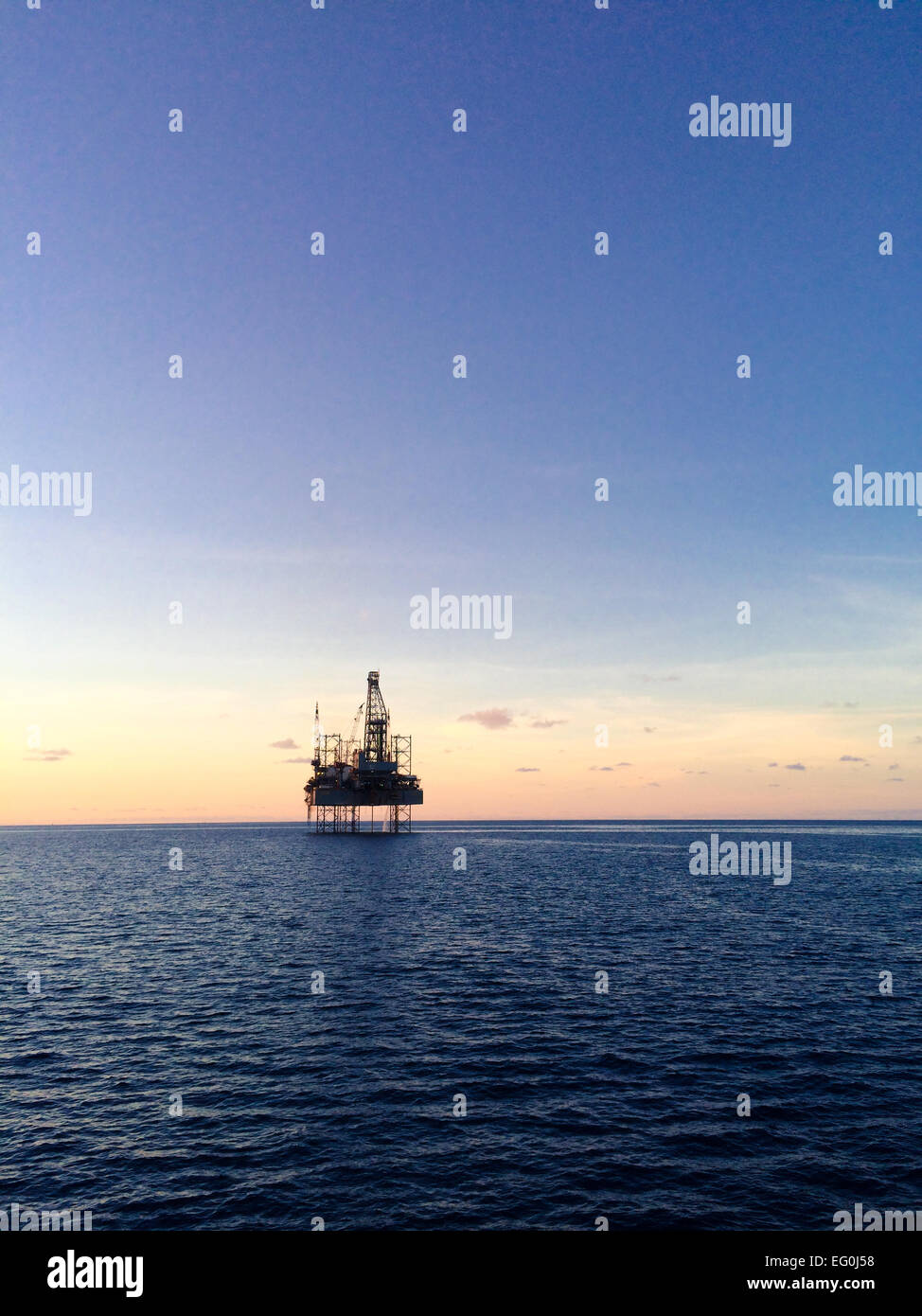 Oil rig at sunset Stock Photo - Alamy