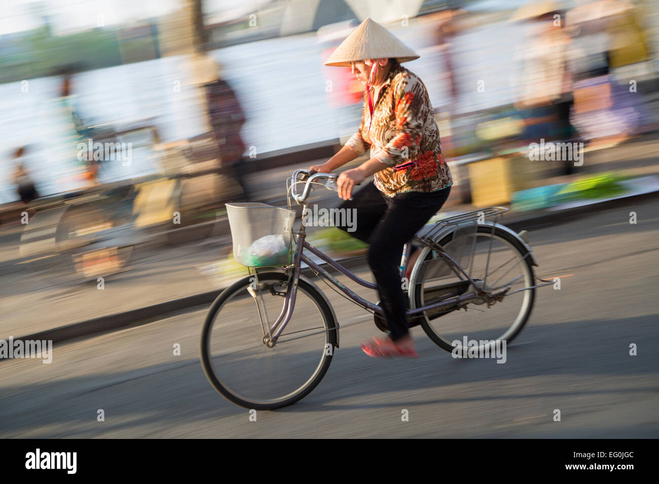 Woman cycling, Ben Tre, Mekong Delta, Vietnam Stock Photo - Alamy