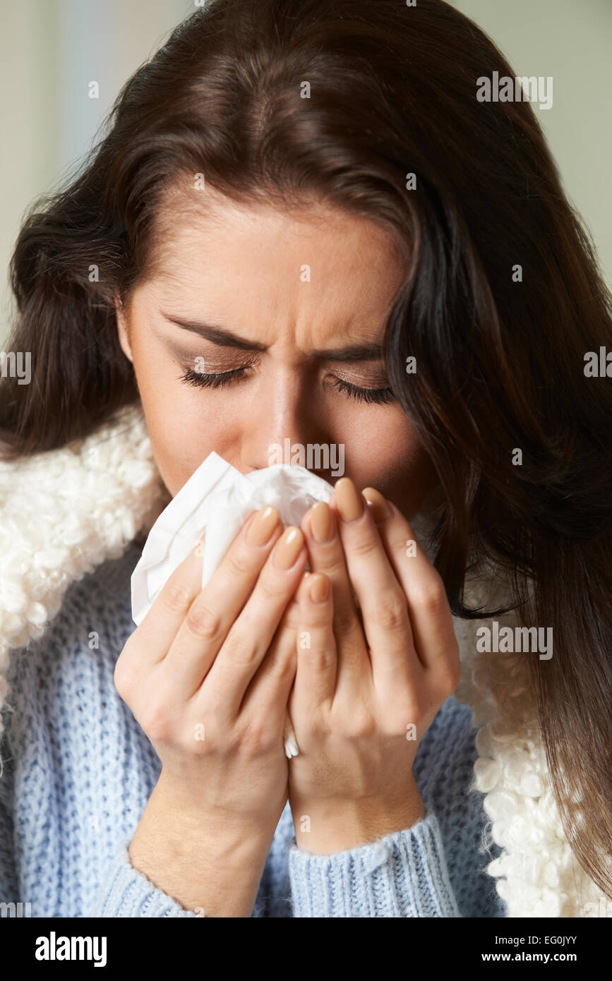 Woman With Cold Holding Tissue And Sneezing Stock Photo - Alamy