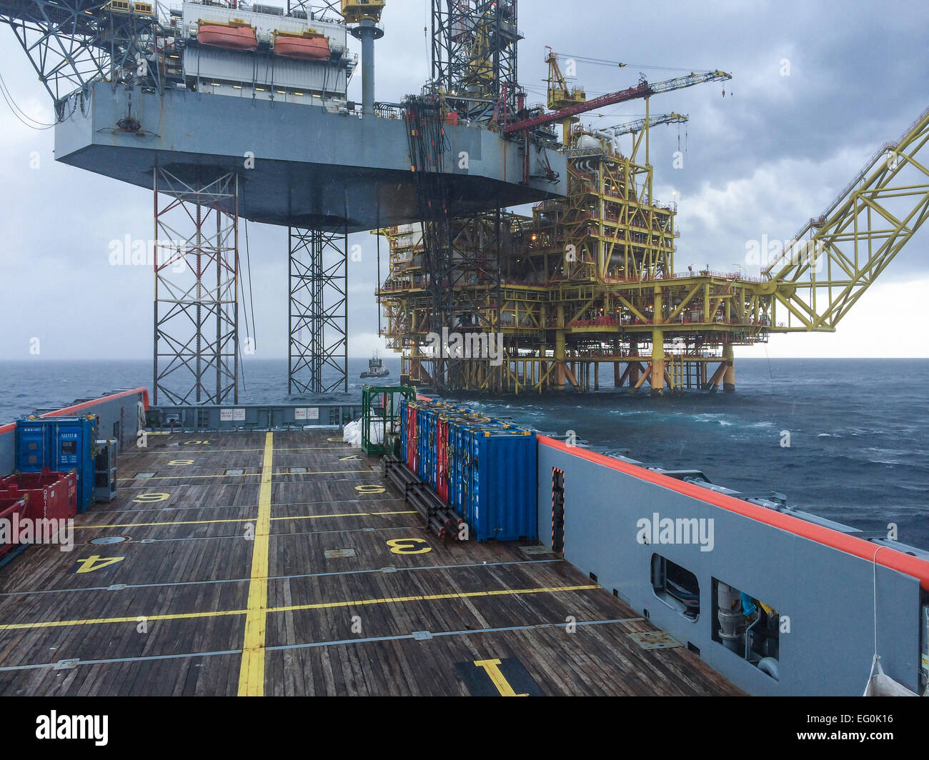 Oil rig support vessel approaching oil rig Stock Photo - Alamy