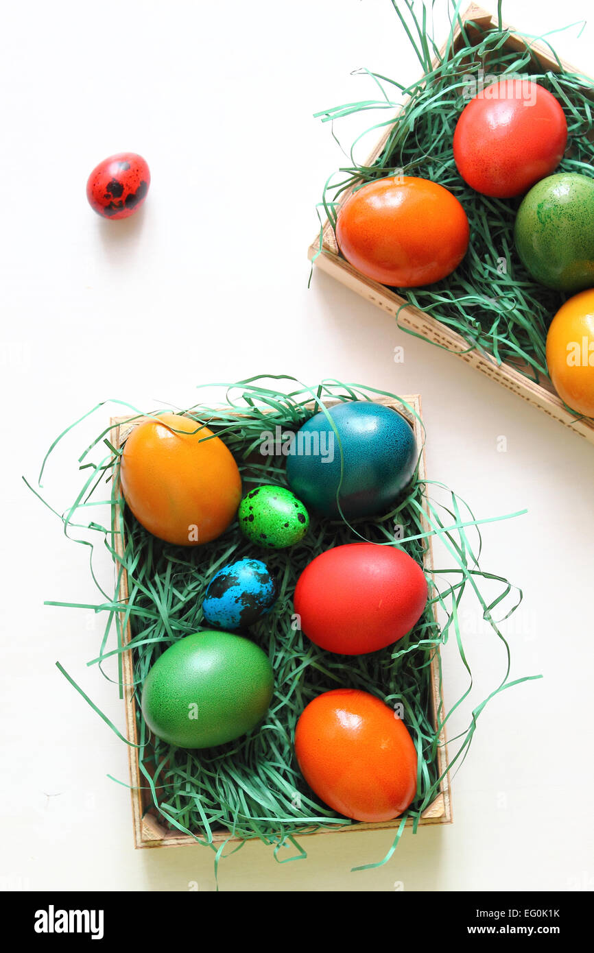 Multicolored Easter eggs on artificial grass in boxes Stock Photo - Alamy