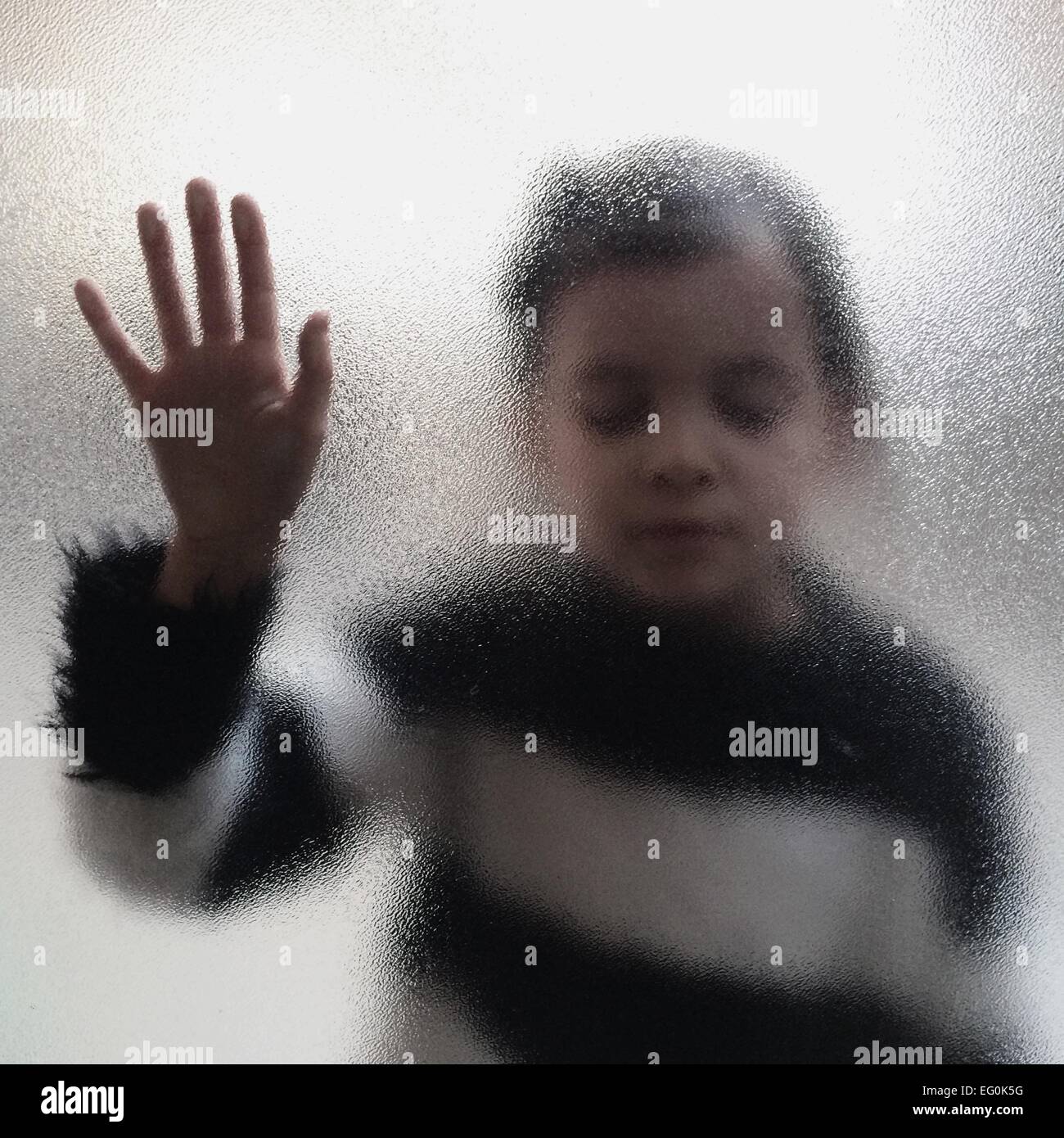 Girl touching frosted glass Stock Photo - Alamy