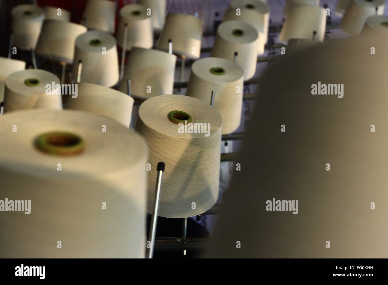 Dhaka 09 February 2015. Group of bobbin thread cones on a warping ...