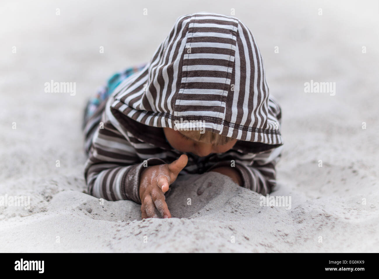Boy playing in sand Stock Photo - Alamy