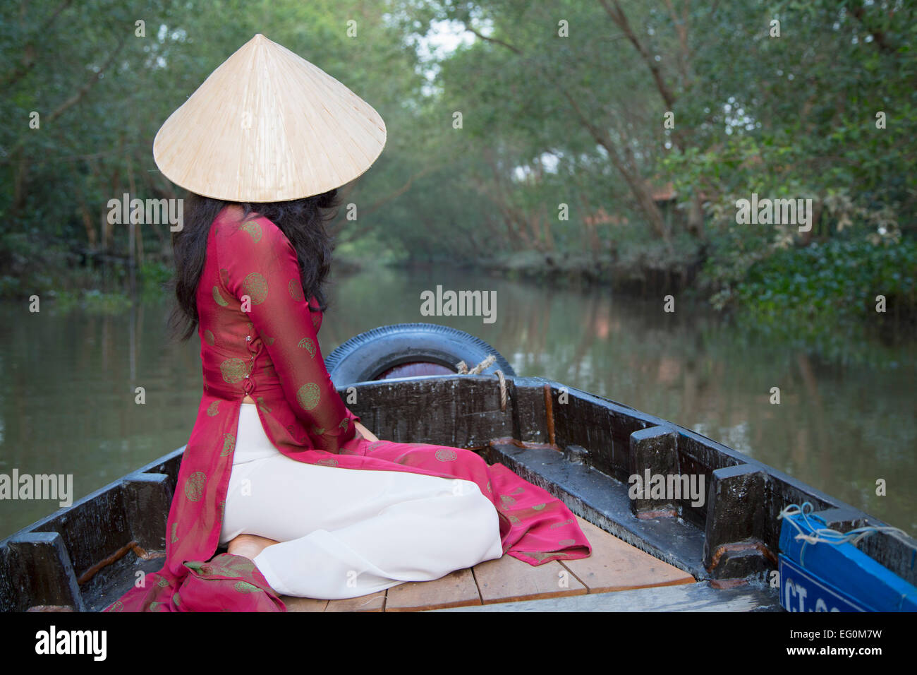 Woman wearing ao dai dress in boat, Can Tho, Mekong Delta, Vietnam ...