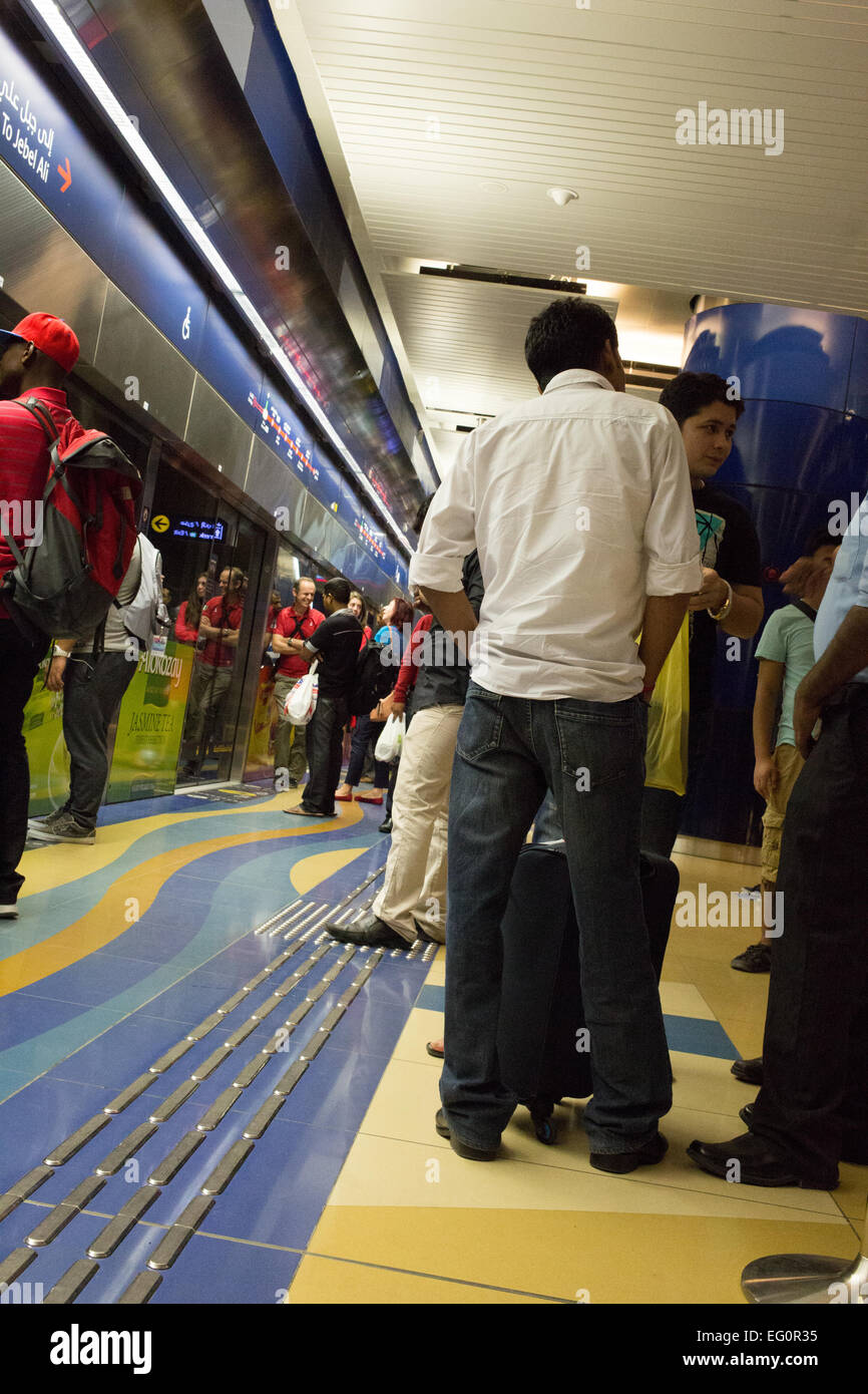 Passengers waiting at a Dubai Metro platform Stock Photo - Alamy