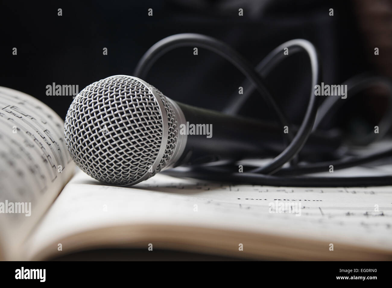 Microphone with cable lying on sheet of music Stock Photo - Alamy