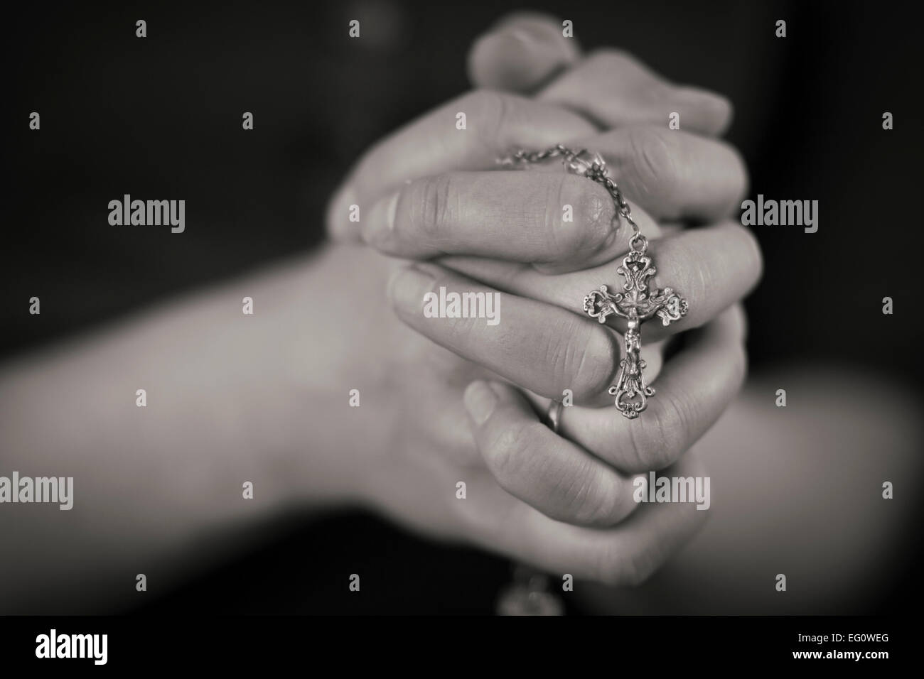 Woman folding hands and pray to God Stock Photo - Alamy