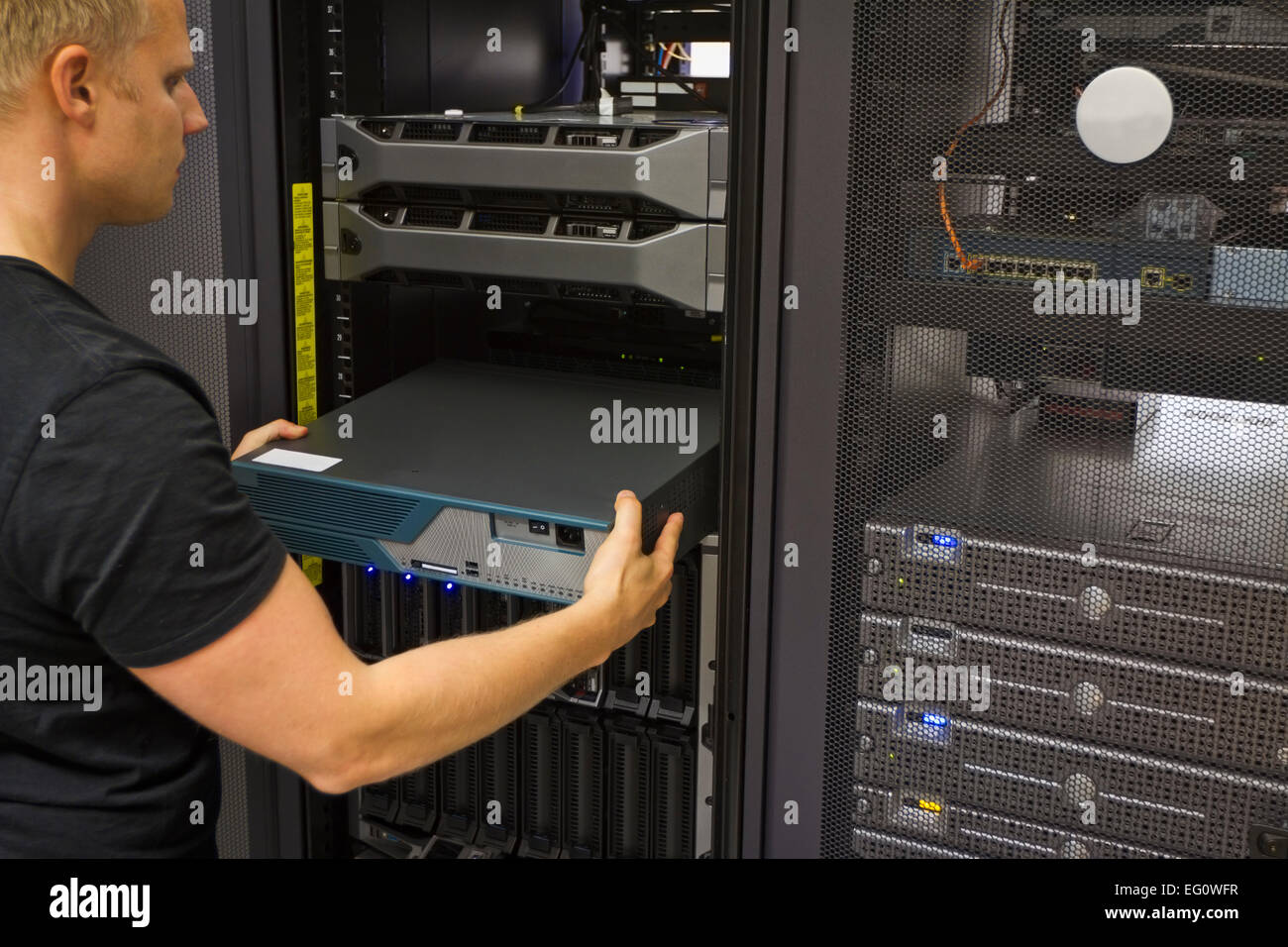 Technician install network rack in hi-res stock photography and images ...
