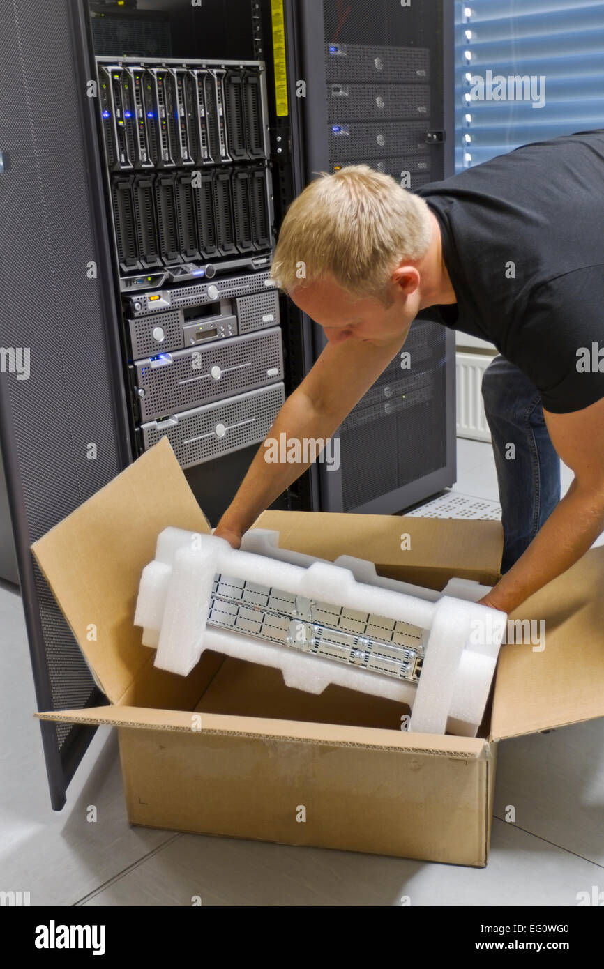 It engineer / consultant install / unpack a server or a network router ...