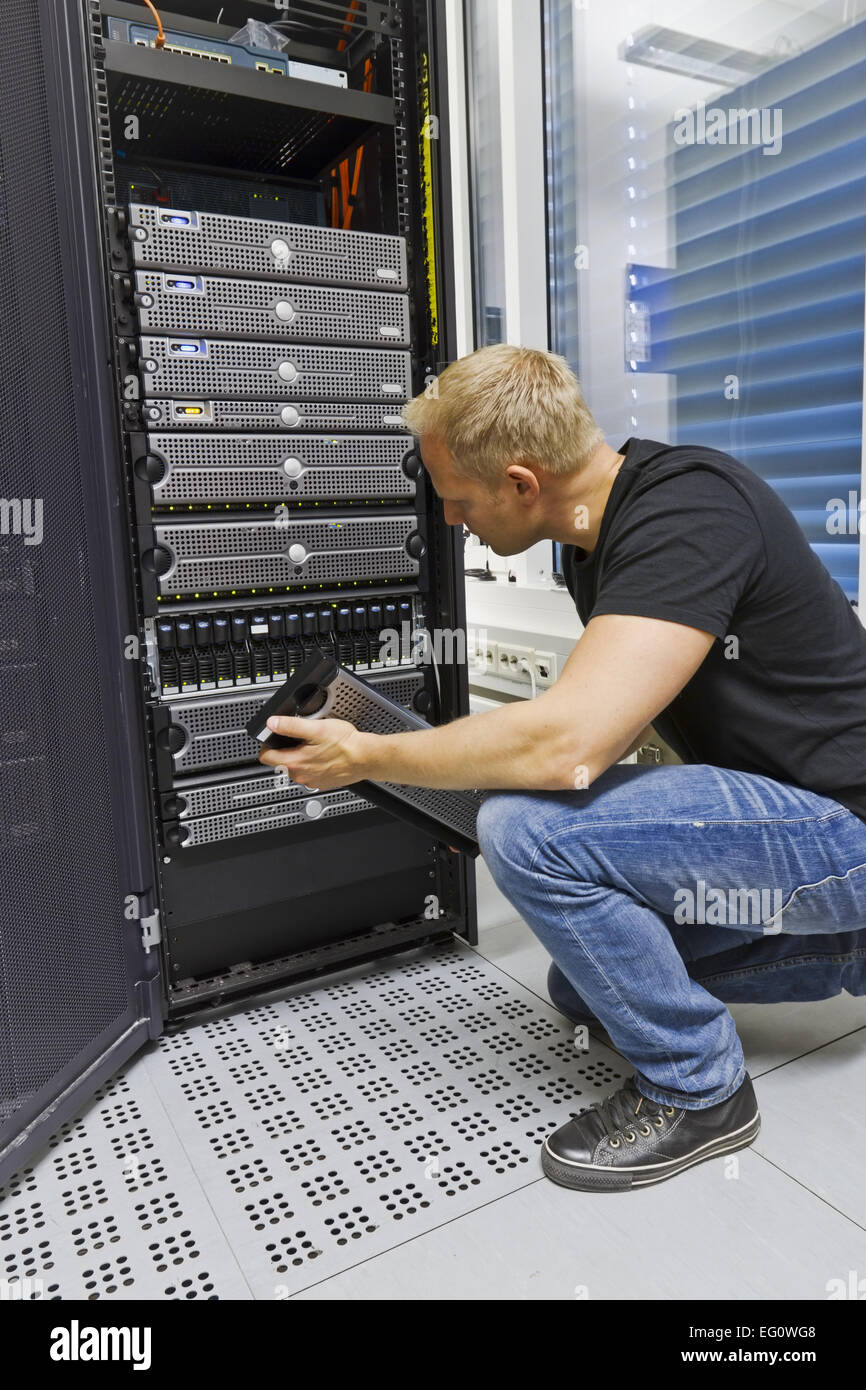 It engineer / consultant working in a data center. Holding a disk ...