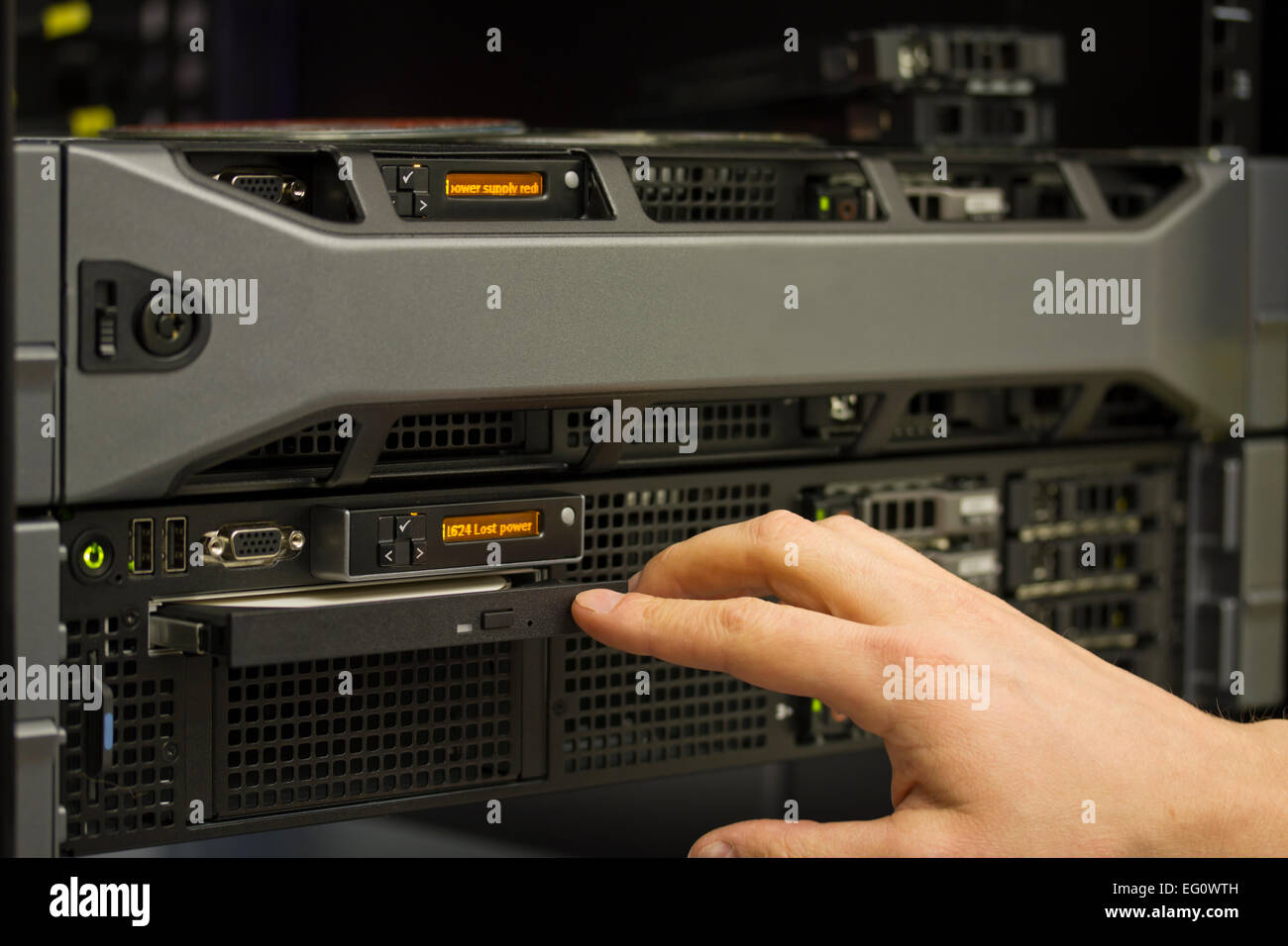 A technician install a 2 unit rack server in a data center Stock Photo ...