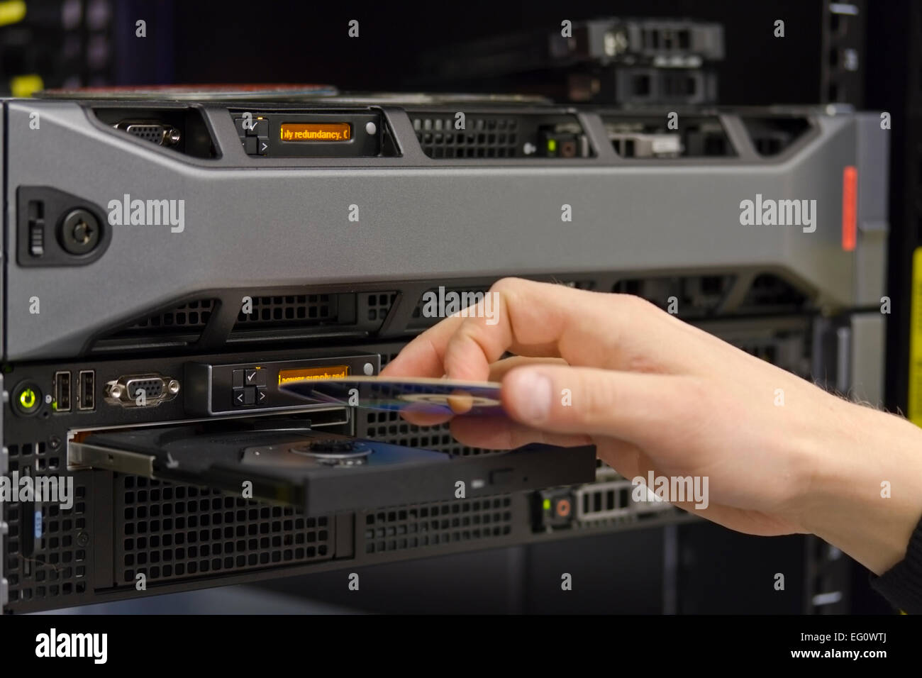 A technician install a 2 unit rack server in a data center Stock Photo ...