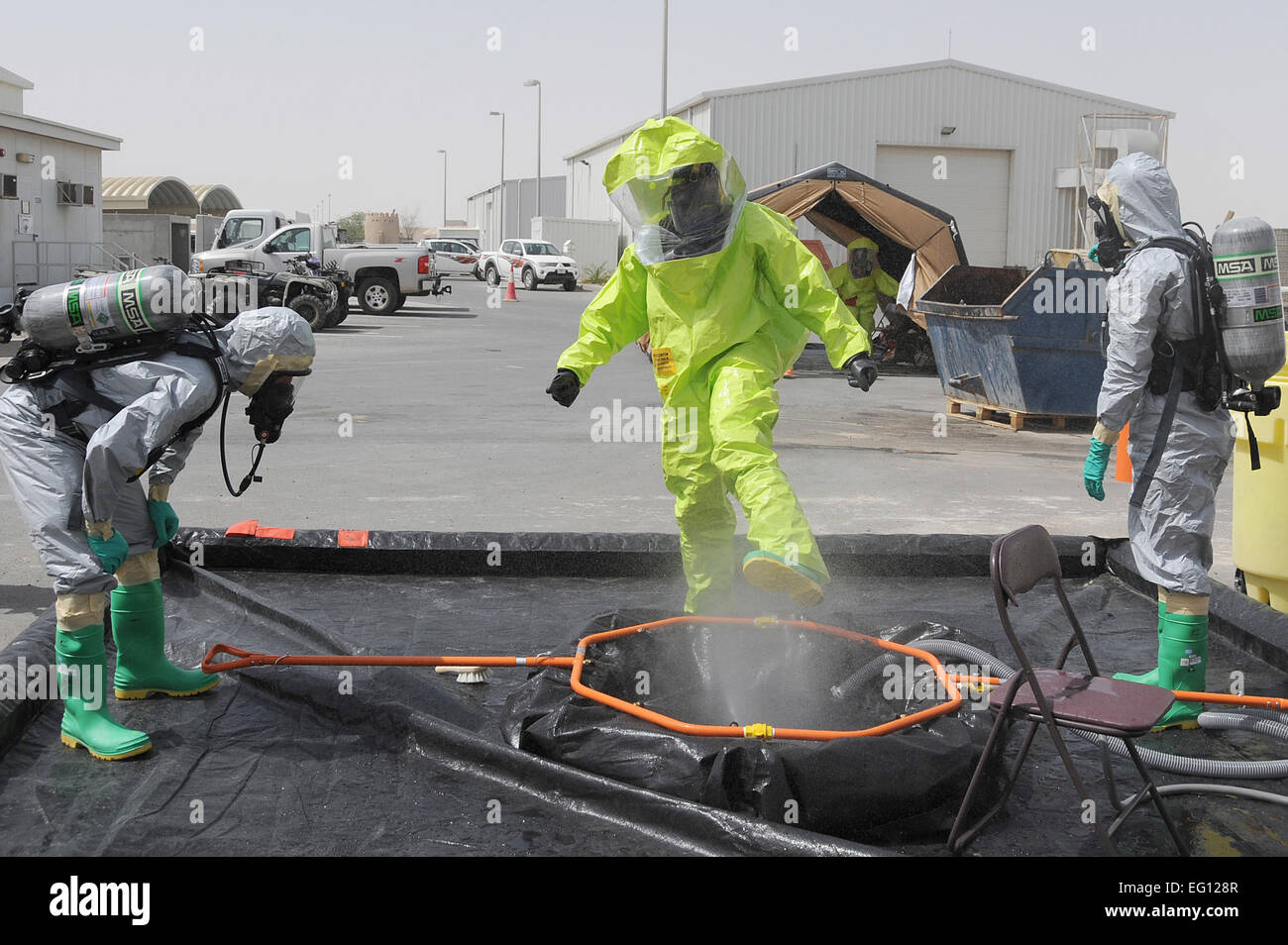 Staff Sgt. Demetrius Thompson steps into a decontamination area while ...
