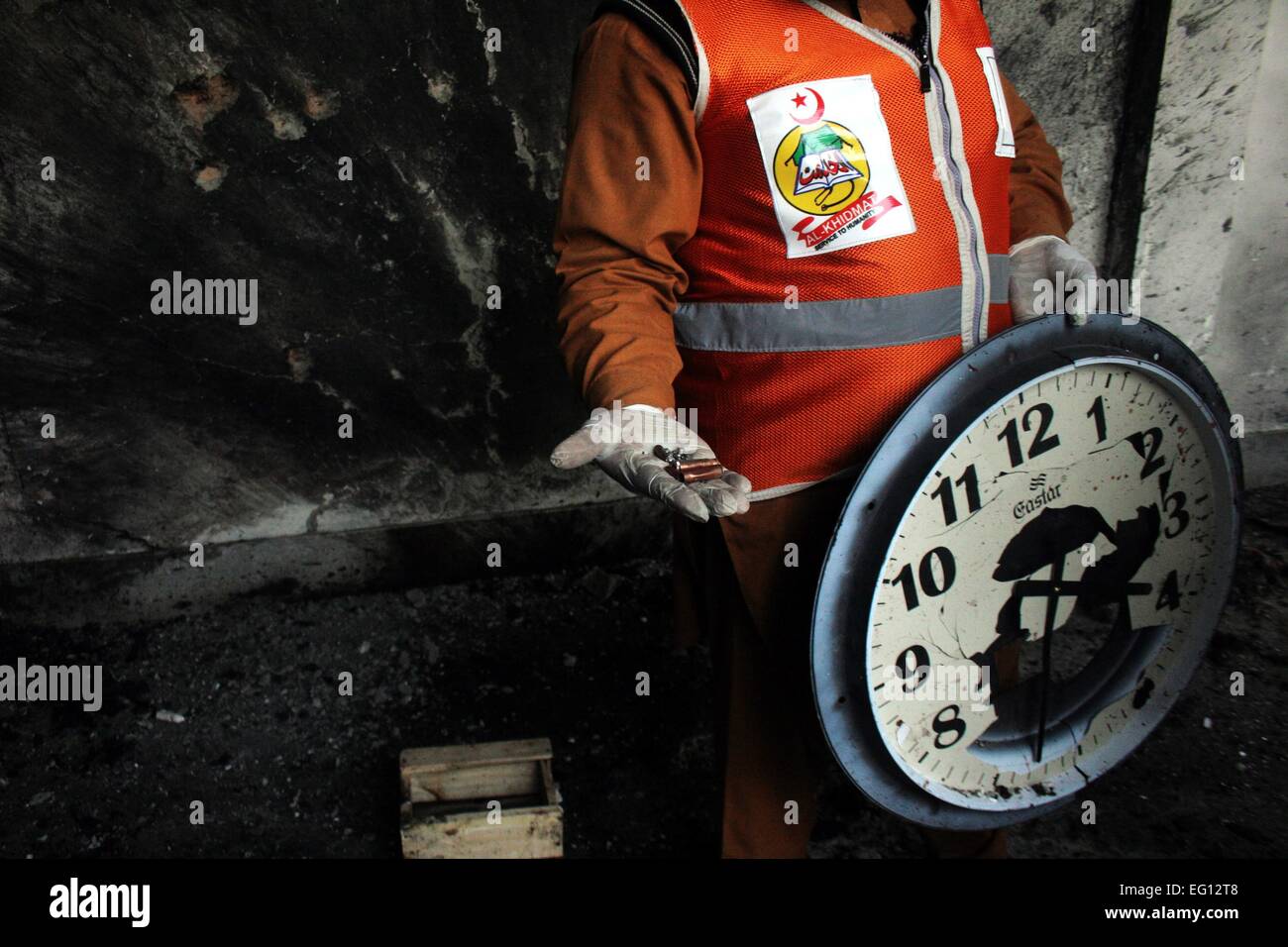 Peshawar, Pakistan. 13th Feb, 2015. A Pakistani rescuer shows bullet ...