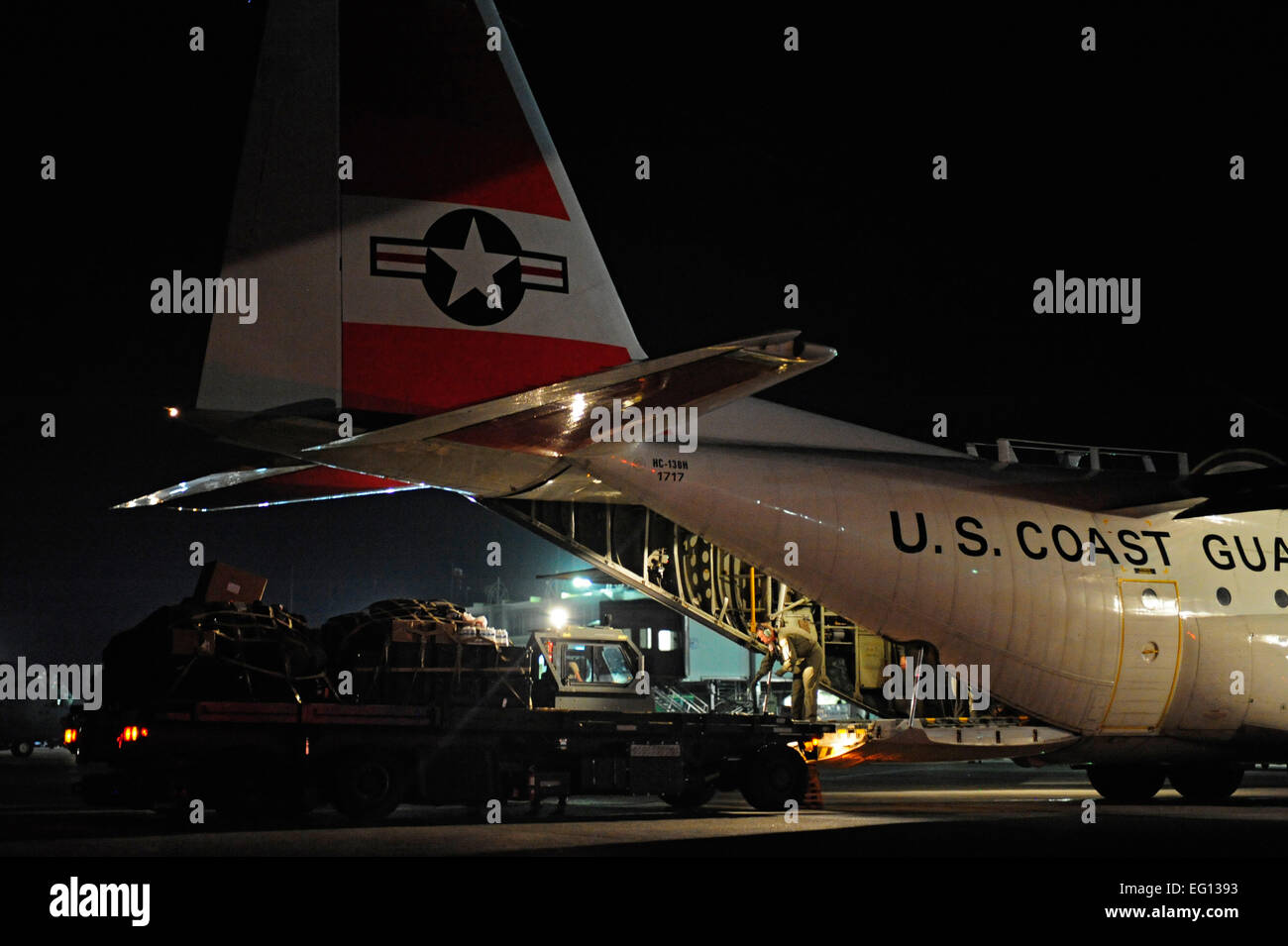 U.S. Air Force Airmen unload a U.S. Coast Guard C-130 Hercules aircraft ...
