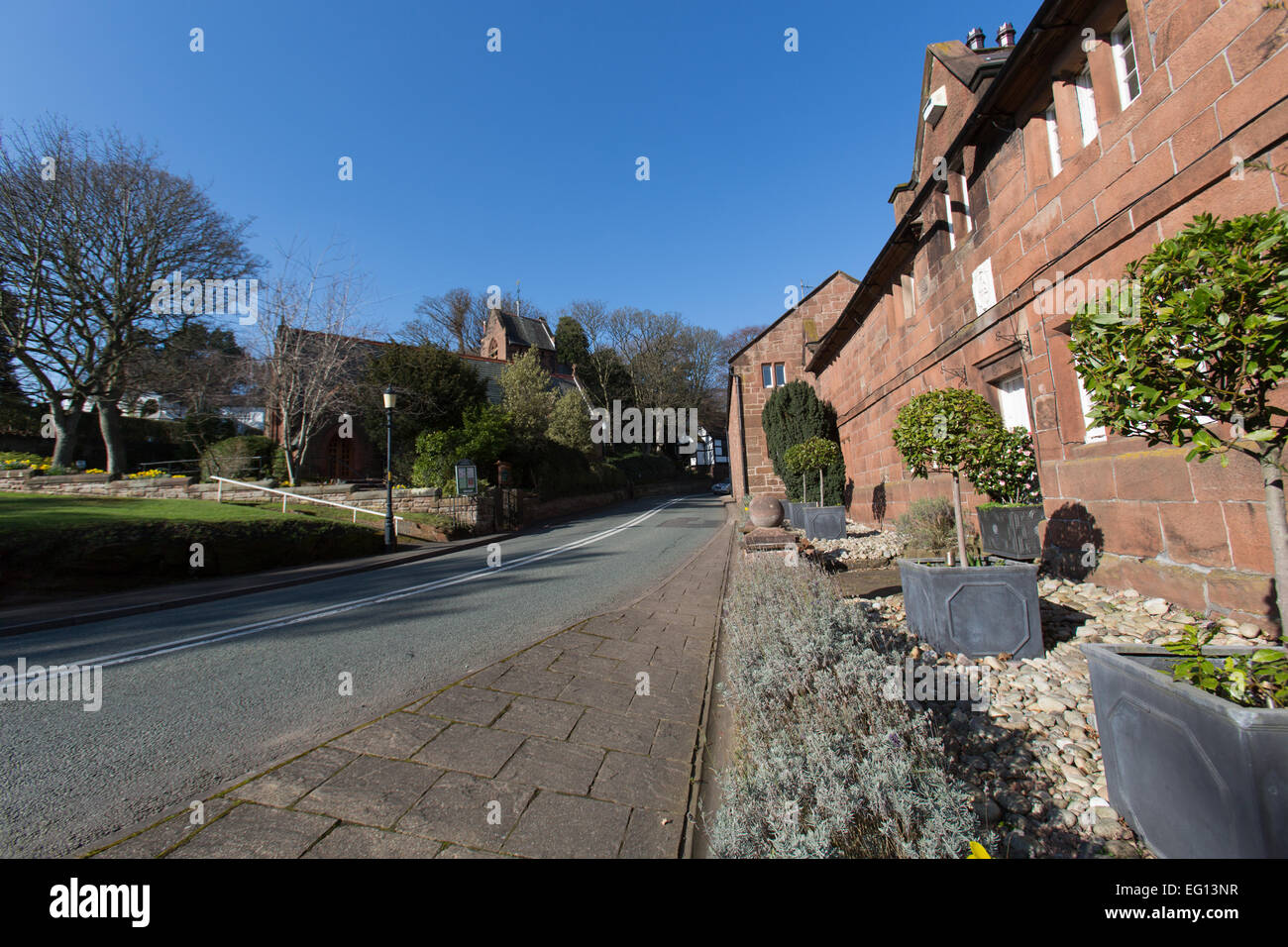 Village of Caldy, Cheshire. Picturesque view of the B5141 road running ...
