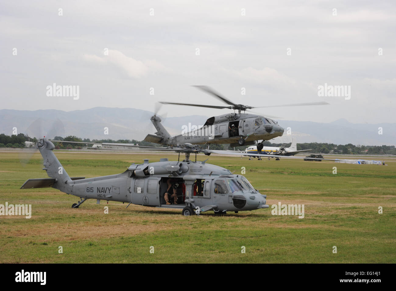 U.S. Navy HA-60 helicopters take off from the airport in Port au Prince ...