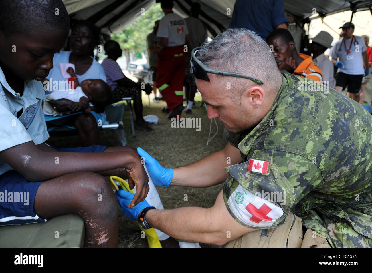 Canadian Army medic Cpl. Champagae Leblanc, treats a injured Haitian ...