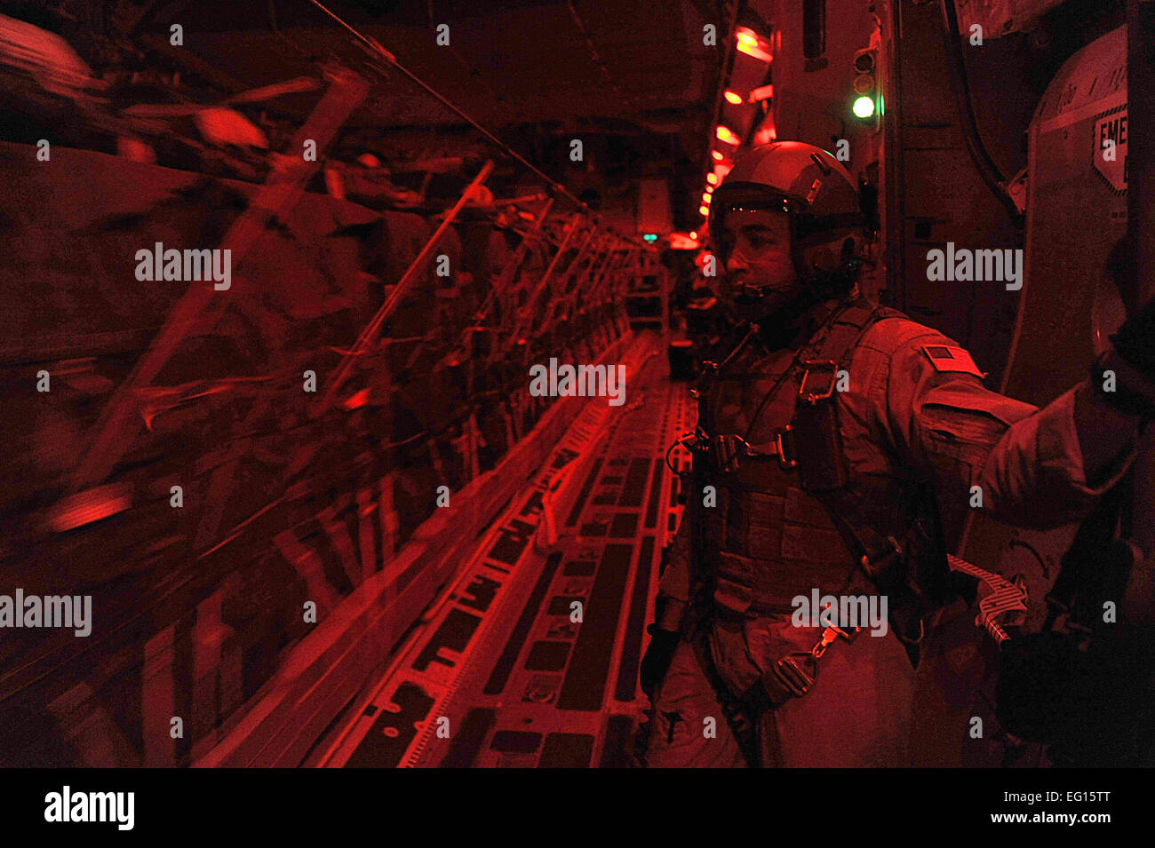 U.S. Air Force loadmaster Senior Airman Kevin Johnson watches as ...