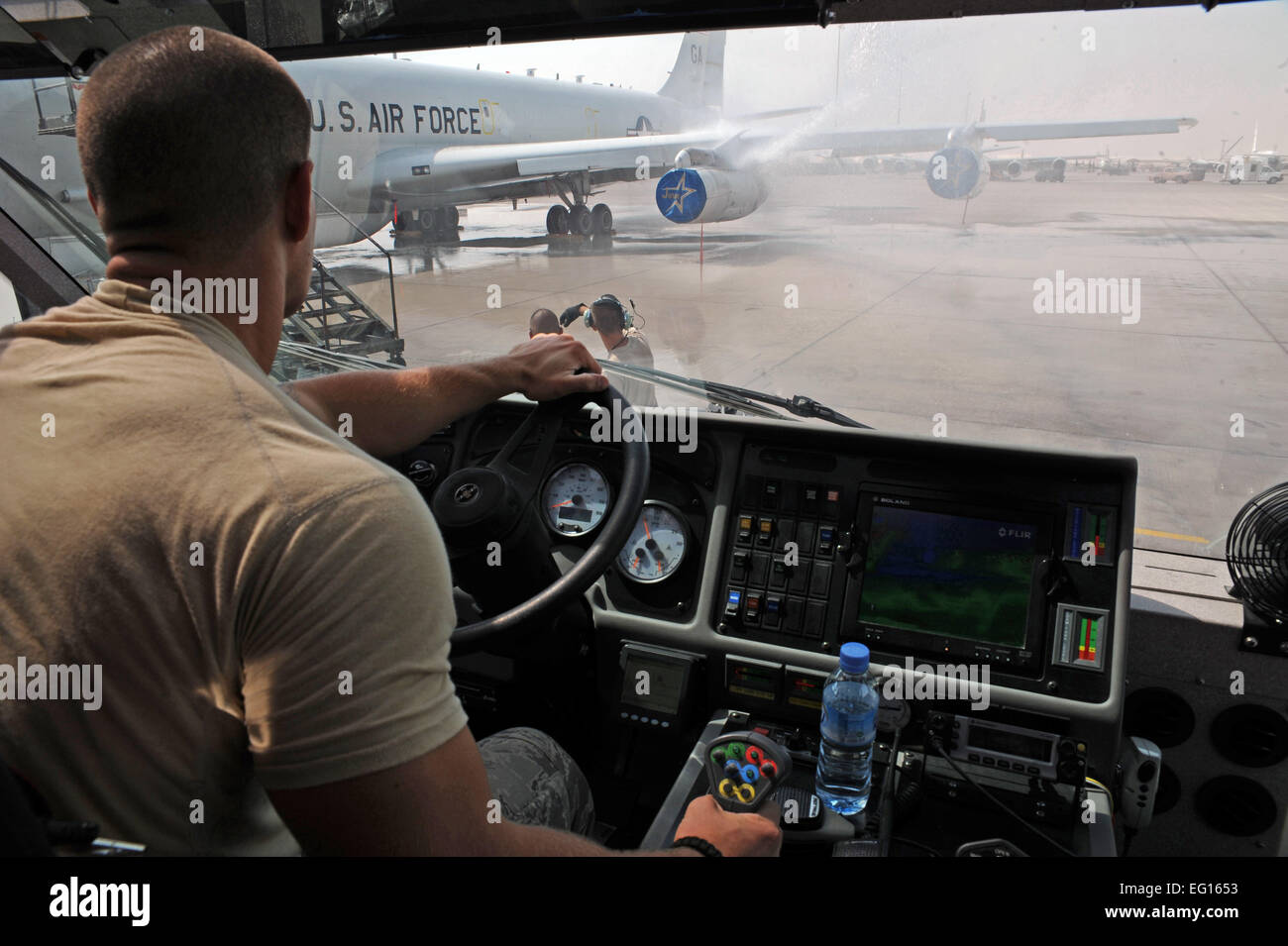 Senior Airman Scott Adams operates roof turret to spray down an ...