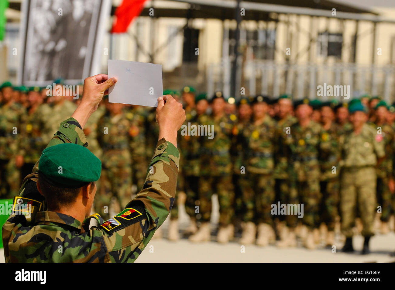 An Afghan National Army soldier holds up his diistinguished graduate ...