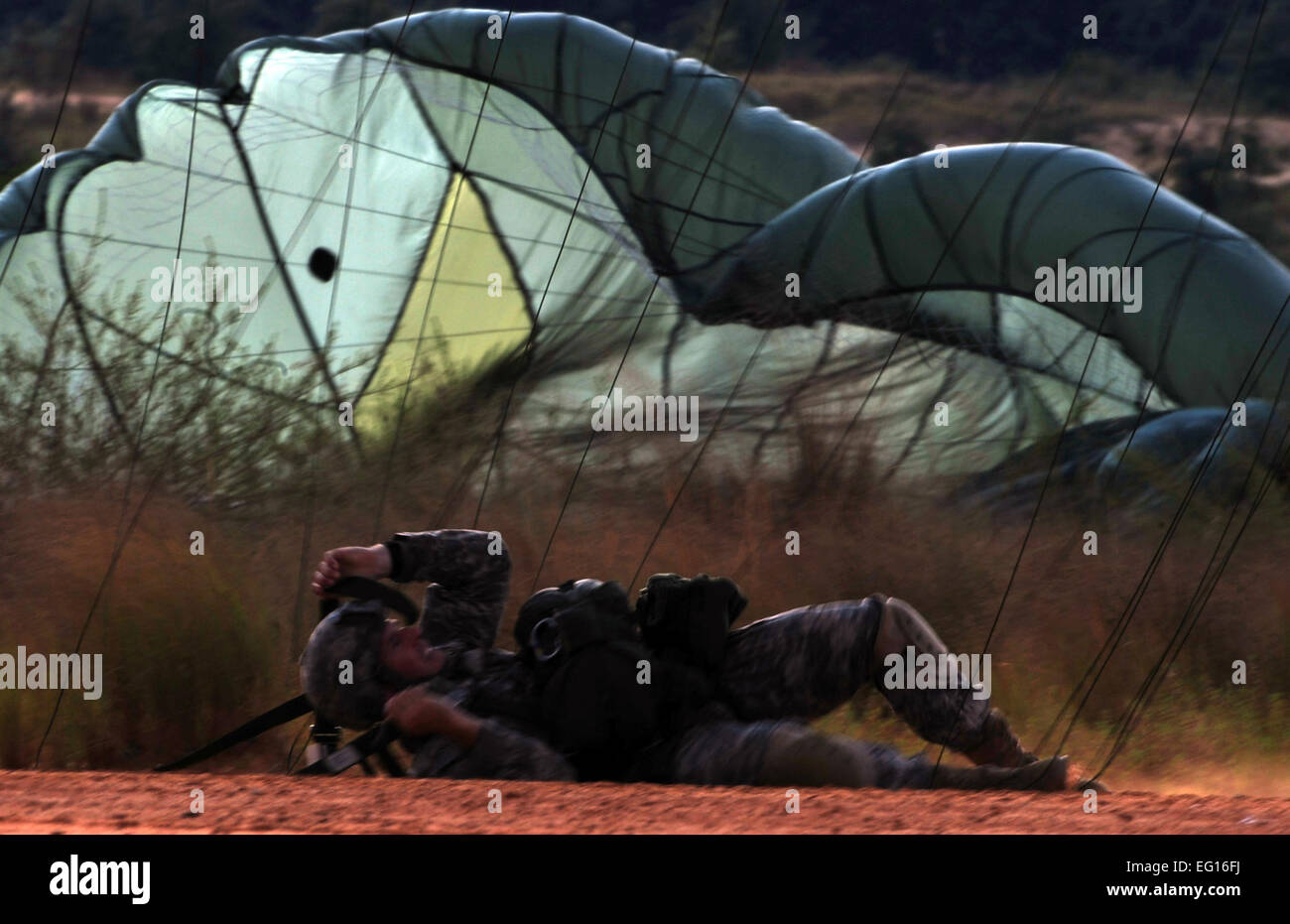A member of the Army's 82nd Airborne Paratroops lands after jumping ...