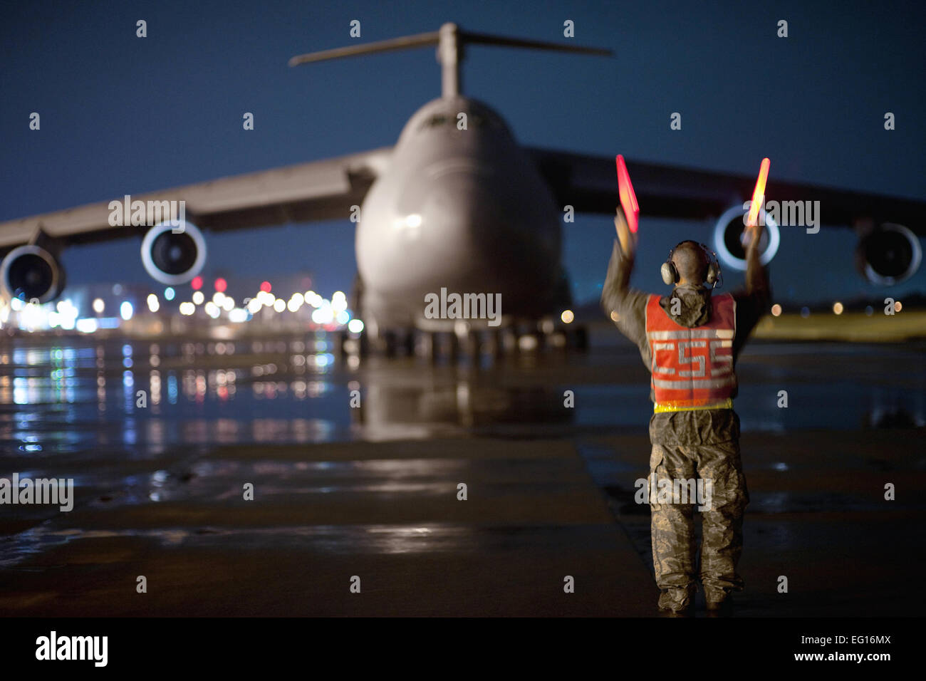 Staff Sgt. Dustin McComas, 730th Air Mobility Squadron, marshals a C-5 ...