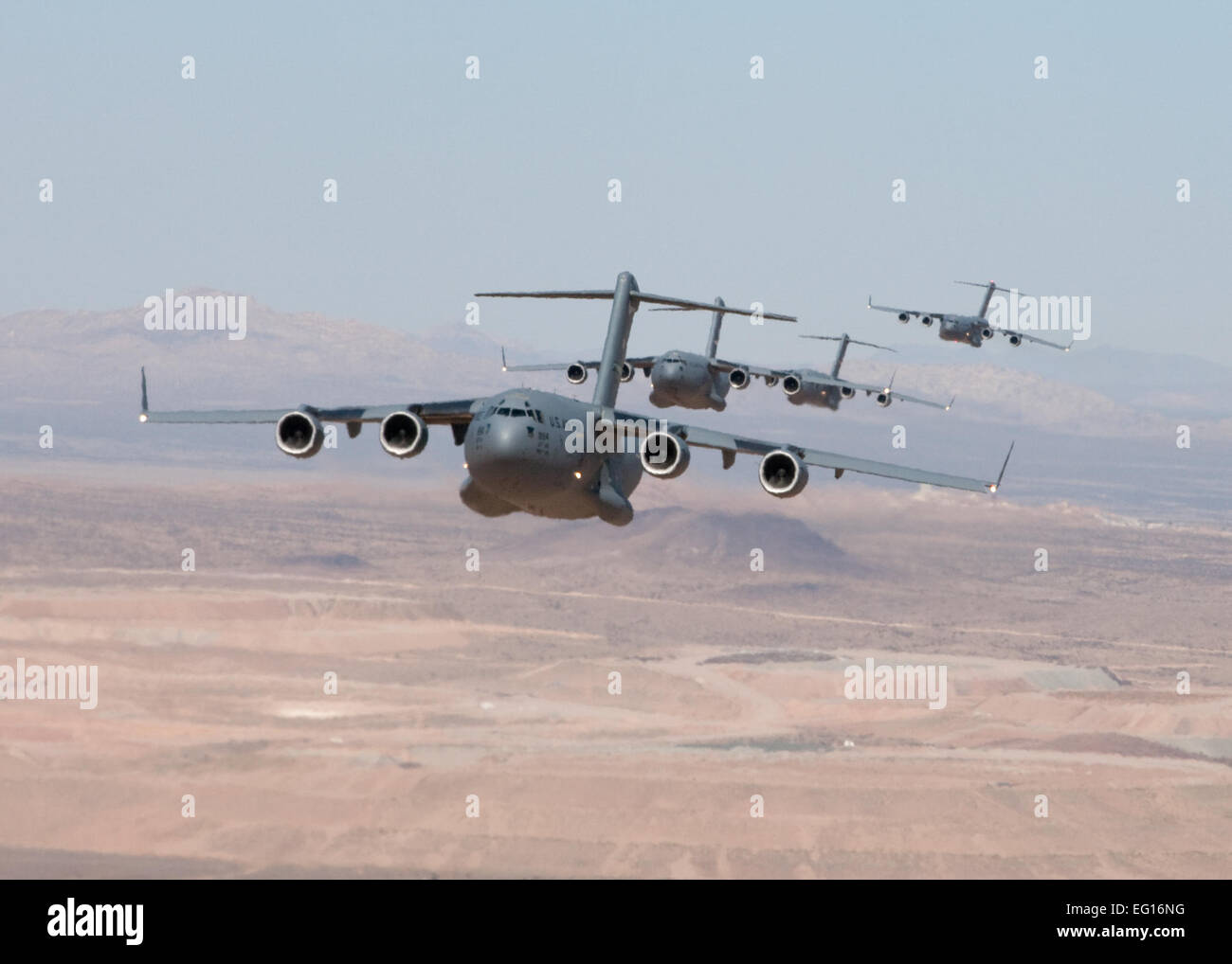 Four U.S. Air Force C-17 Globemaster III cargo aircraft fly in a ...