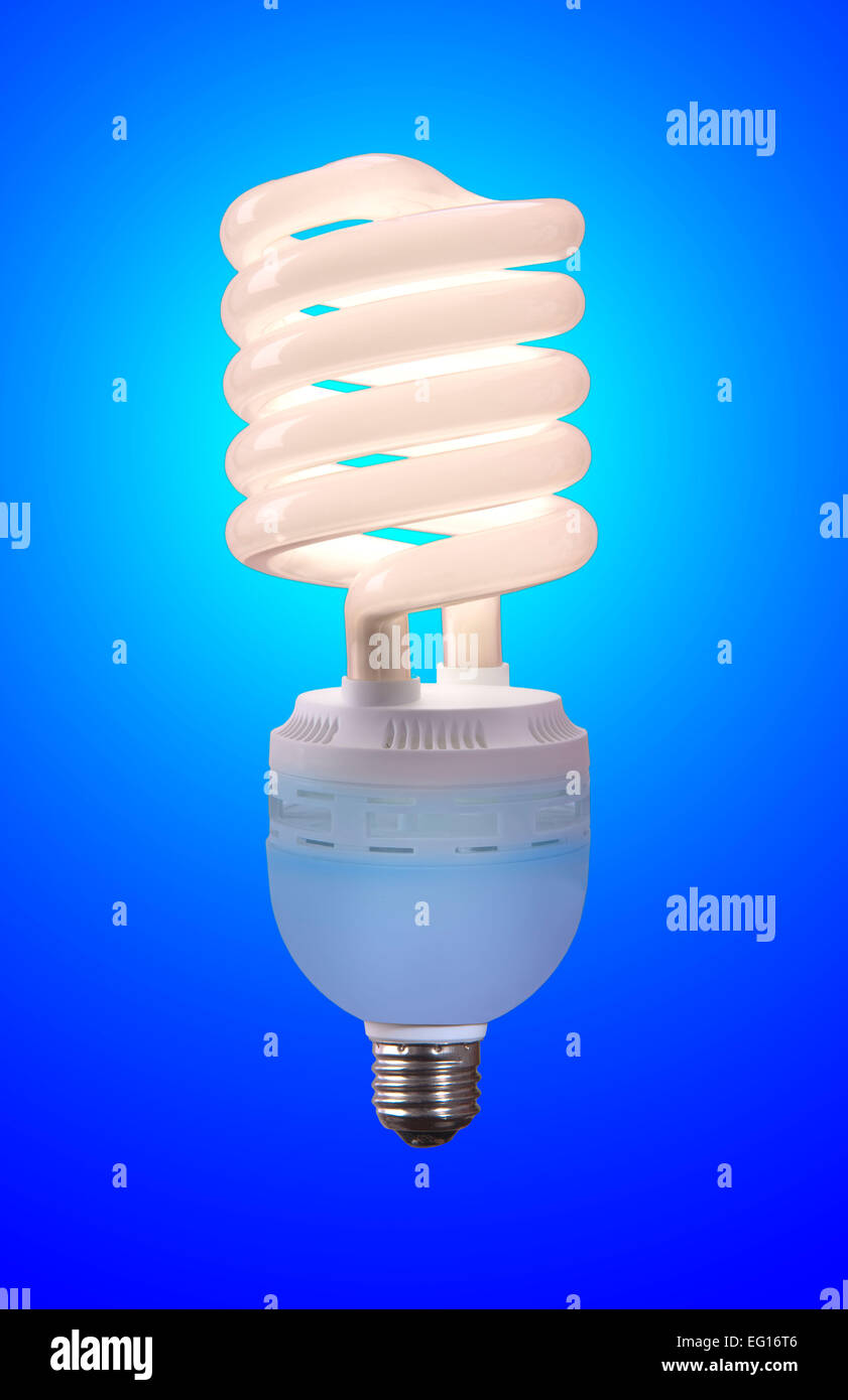 Energy saving light bulb on on blue background Stock Photo - Alamy