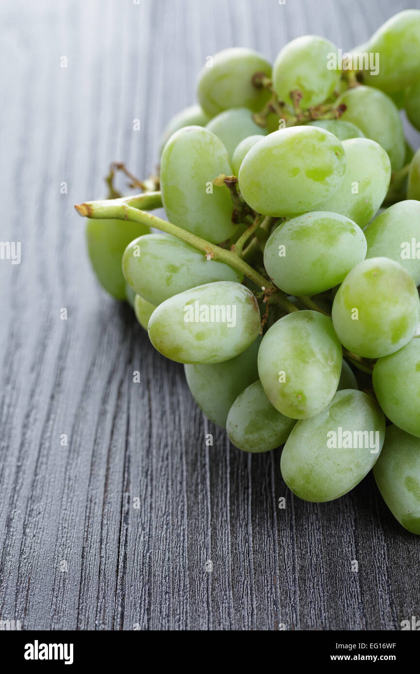ripe green grapes on black wood table Stock Photo - Alamy
