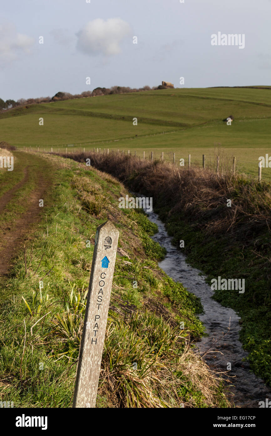 Wooden sign for the Southwest Coastal path alongside points the way ...