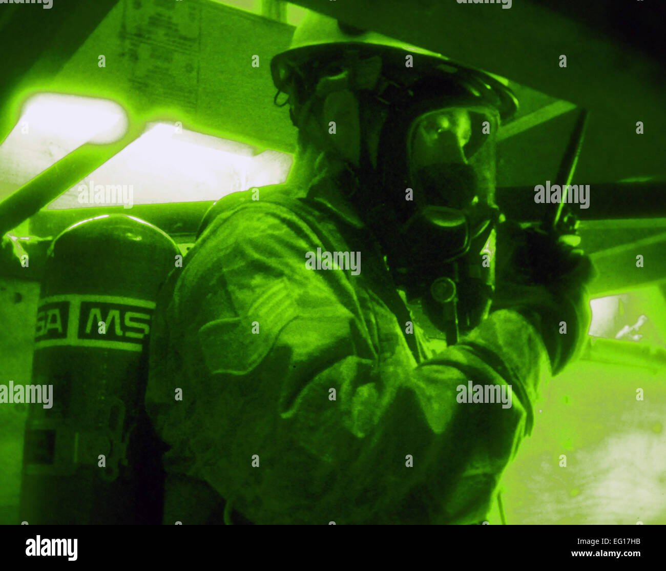 Staff Sgt. Matthew Pugh radios information during a rappelling exercise ...