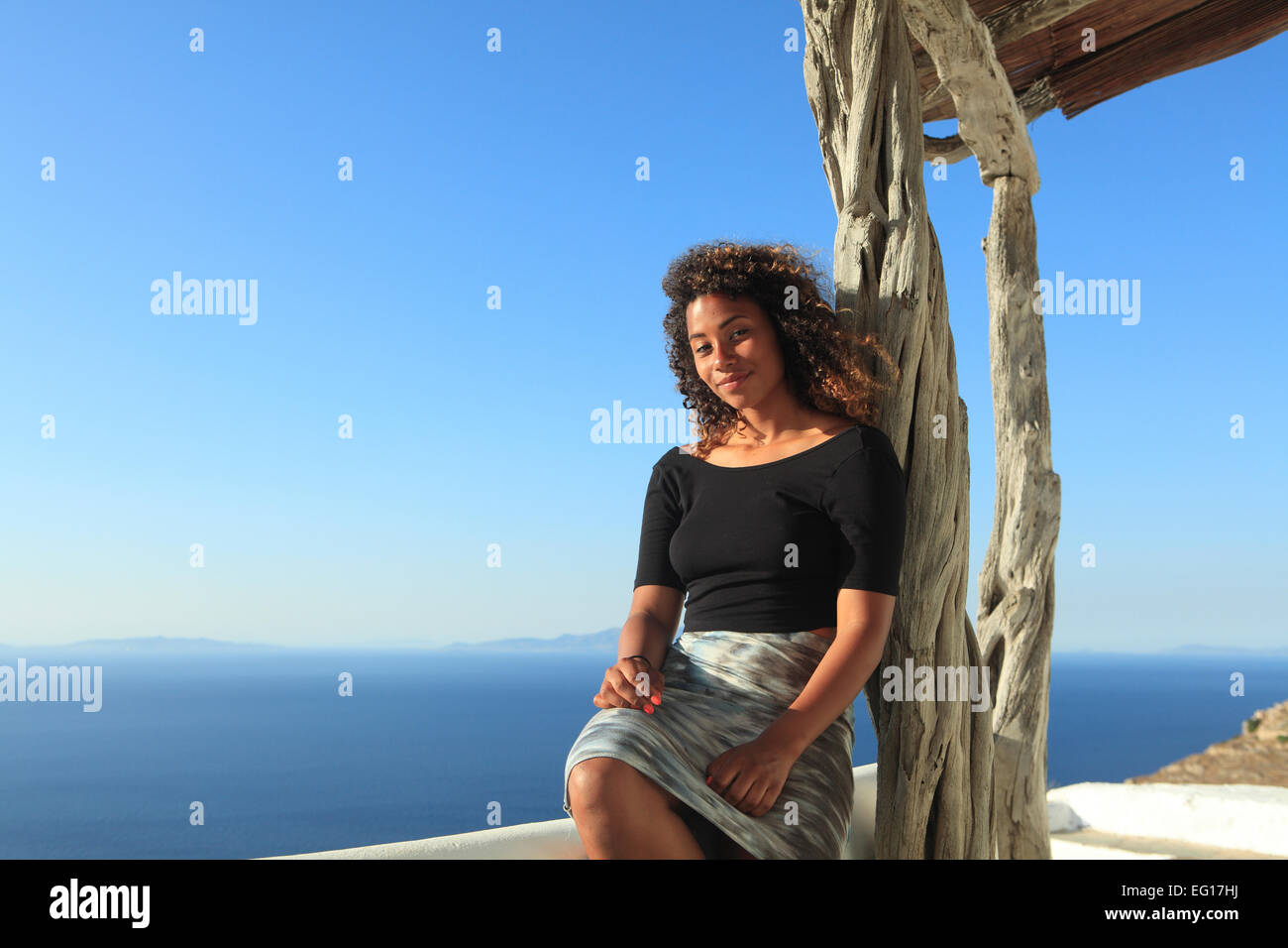 greece a young mixed race girl posing on holiday Stock Photo - Alamy