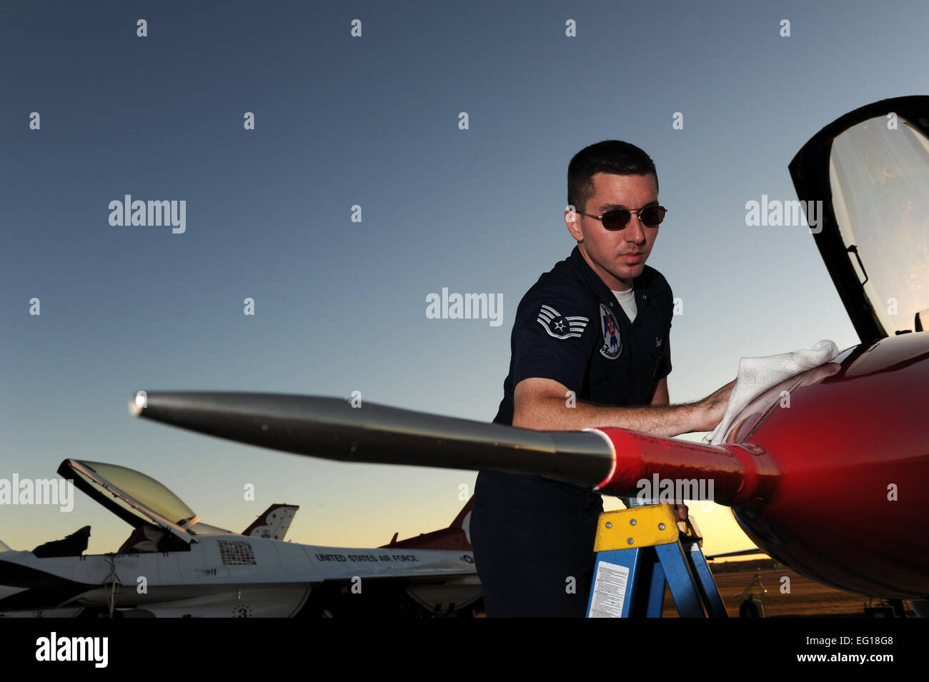 Staff Sgt. Zachary French, a Thunderbird crew chief, wipes down his jet ...
