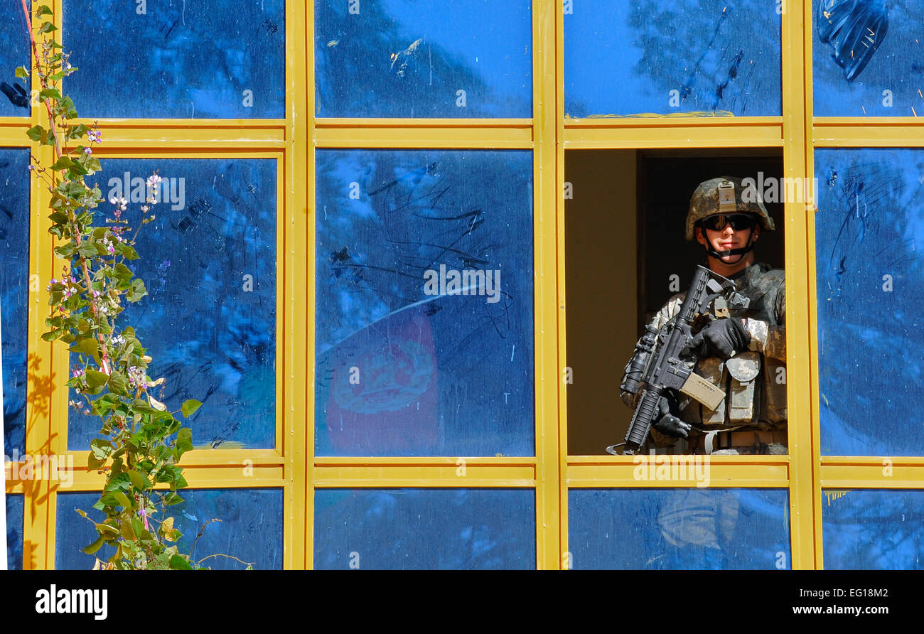 U.S. Army Spc. Zeth Current looks out a window while pulling security ...