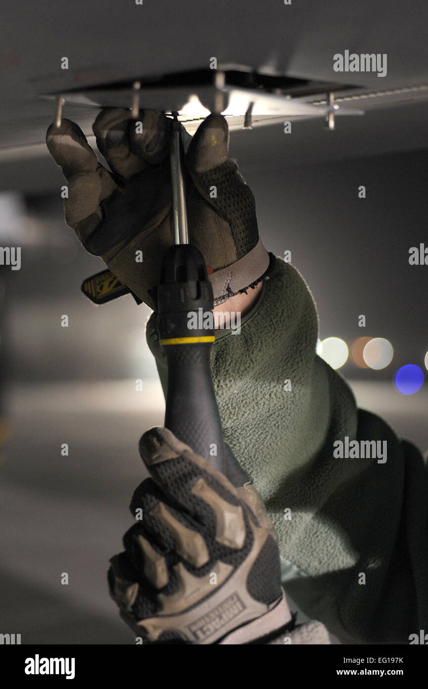 A U.S. Air Force staff sergeant removes a wing access panel on an MQ-9 ...