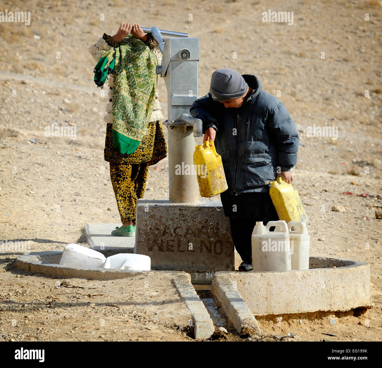 Residents of Khwazi village, Afghanistan, use a well to get water while ...