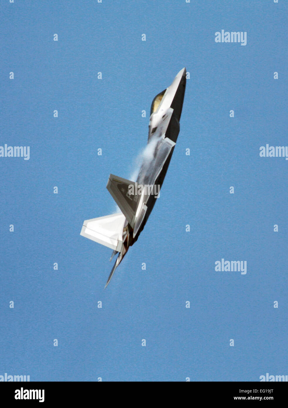 The F-22 Demonstration Team Raptor performs a steep ascent as vapor ...