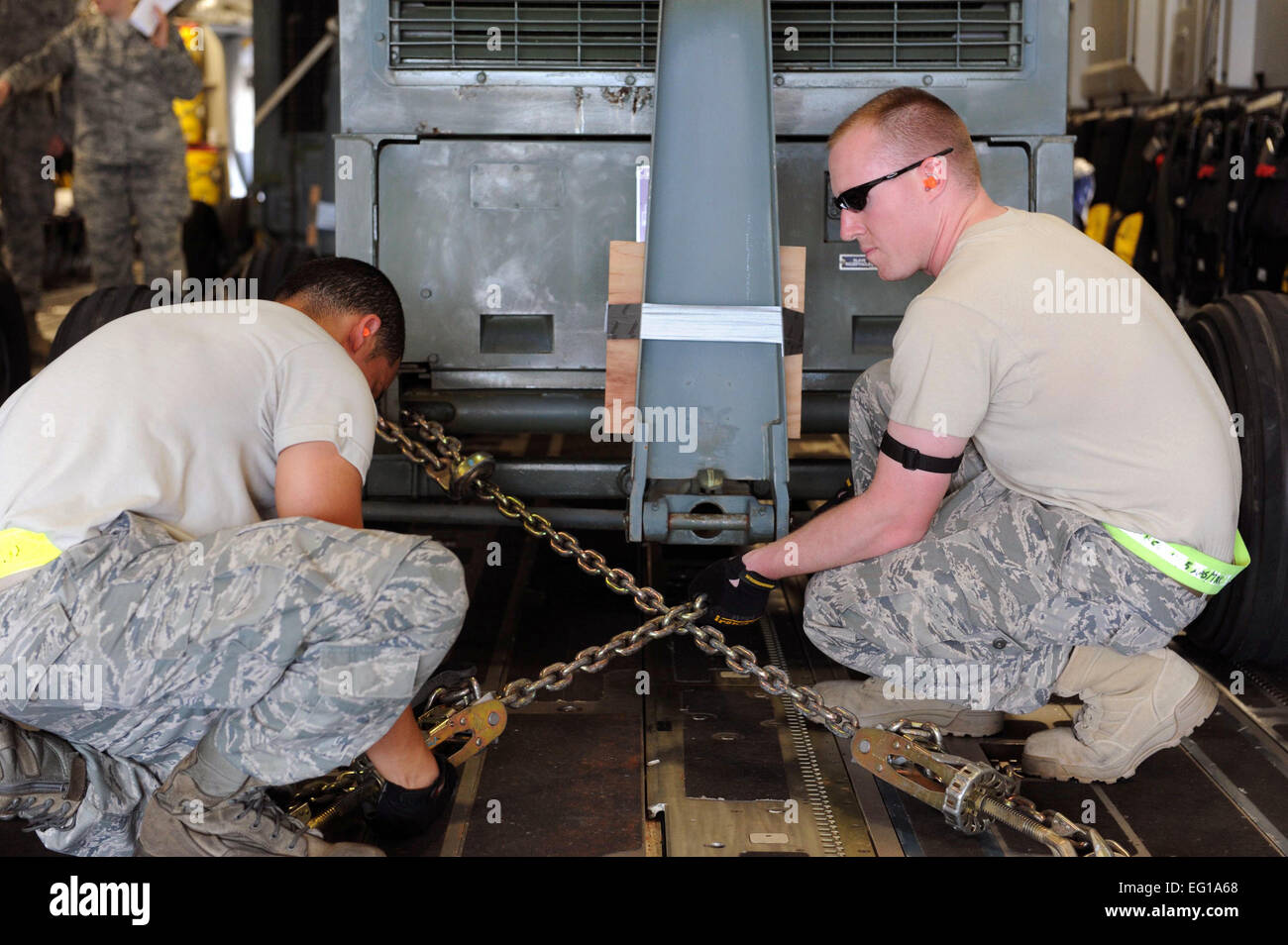Ramp service specialists with the 735th Air Mobility Squadron secure a ...