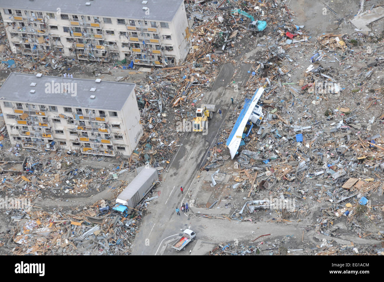 A U.S. Air Force search and rescue team spots a boat tossed on its side ...