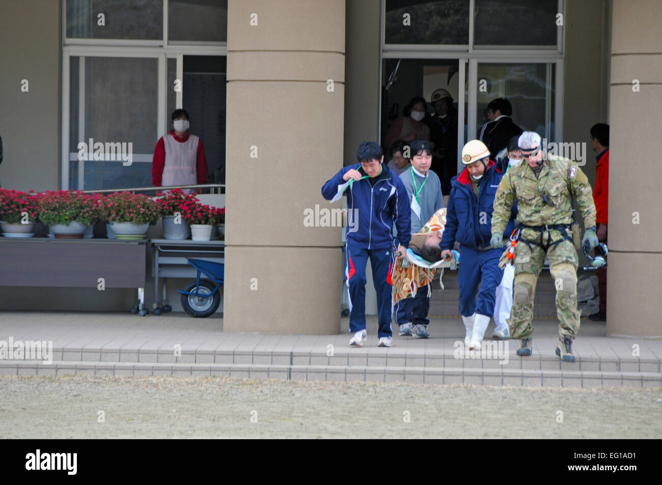 A Japanese disaster medical assistance team carries an earthquake ...