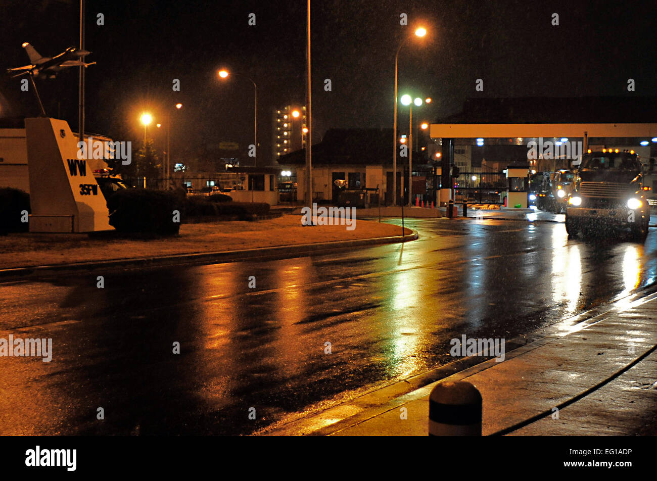 MISAWA AIR BASE, Japan -- A convoy of trucks and buses enters through ...