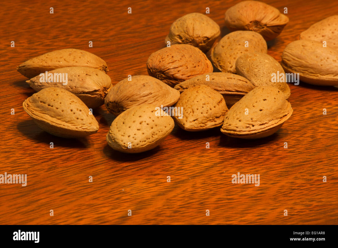 Almonds on wooden table Stock Photo - Alamy