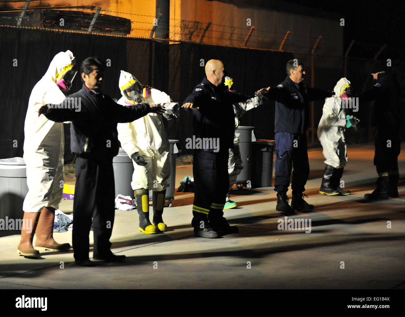 YOKOTA AIR BASE, Japan -- Airmen scan members of the Queenland Urban ...