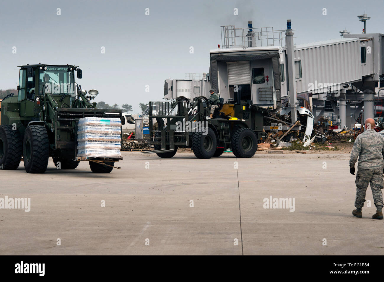 Members of the 353rd Special Operations Group drive forklifts carrying ...