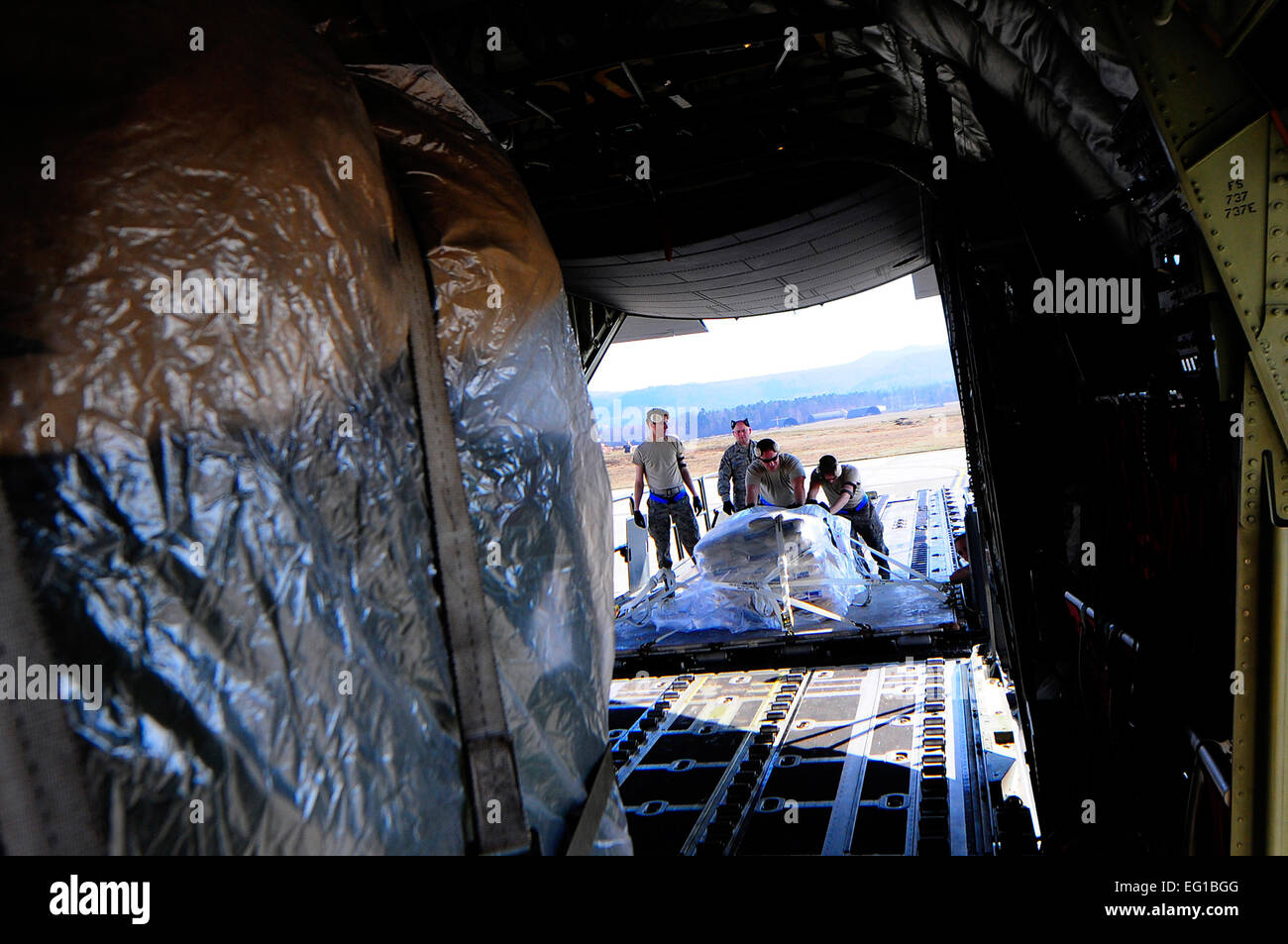 U.S. Air Force Airmen from the 721st Aerial Port Squadron load cargo ...