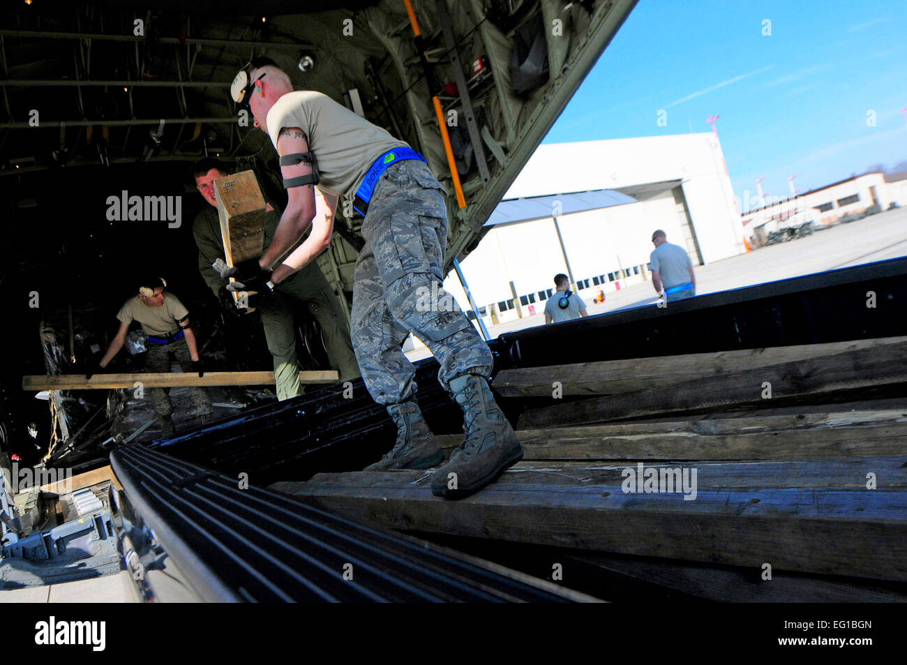 U.S. Air Force Airmen from the 721st Aerial Port Squadron load cargo ...