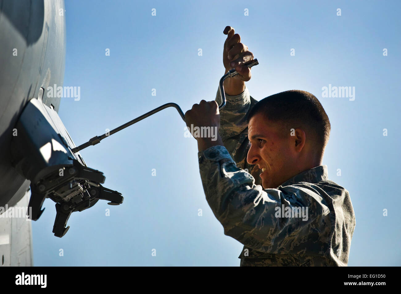 U.S. Air Force Airman 1st Class Earl Condra prepares an Air Force F-15 ...